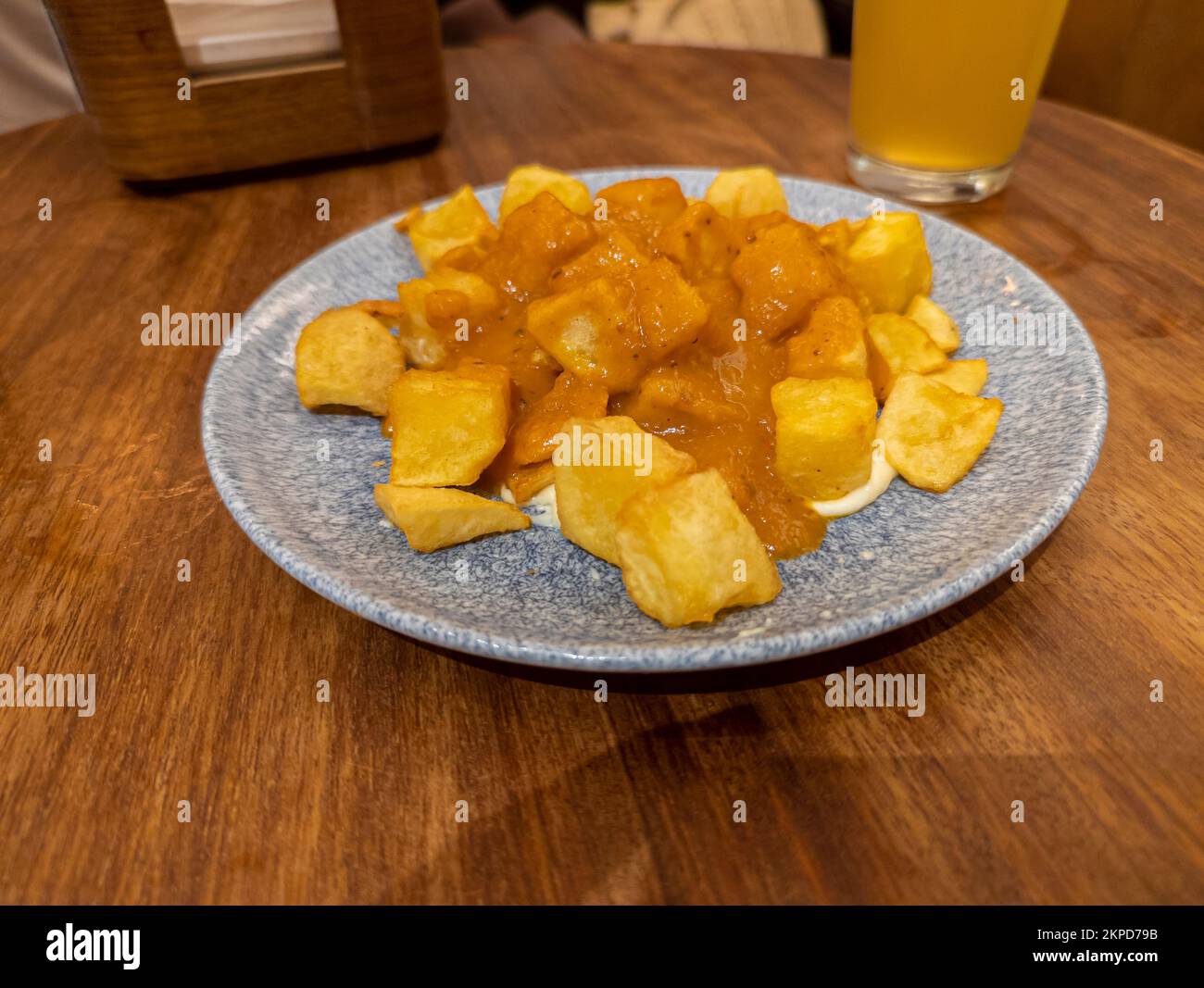 Typical Spanish dish called patatas bravas, fried tubers with red spicy ...
