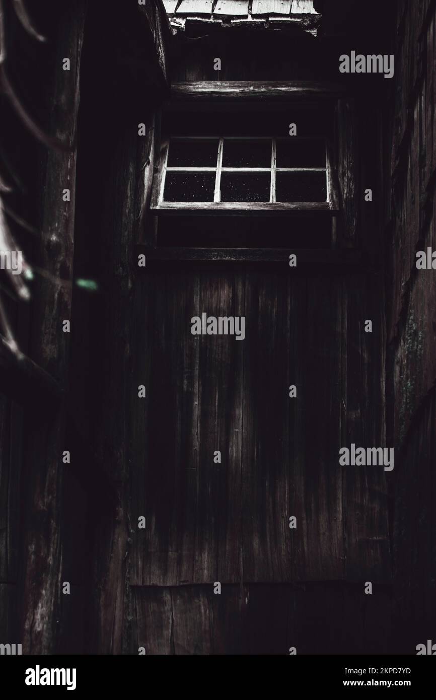 Vertical fine art photo of an open horror window on an abandoned rustic ...