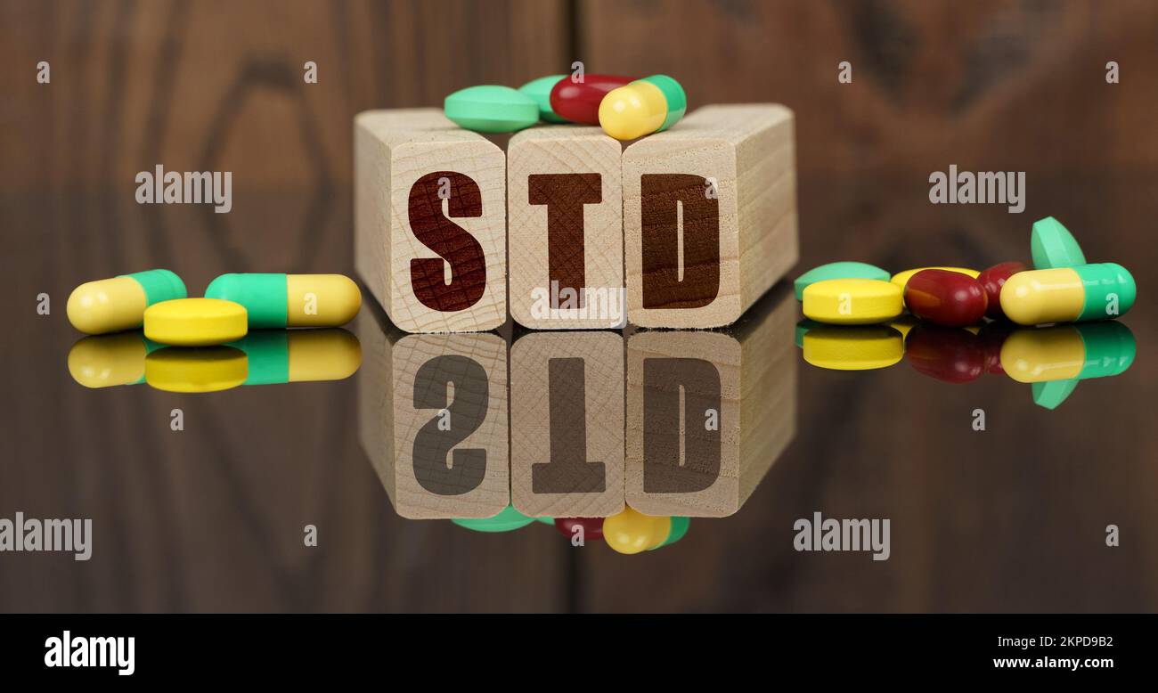 Medicine and health concept. On the surface are visible tablets, wooden ...