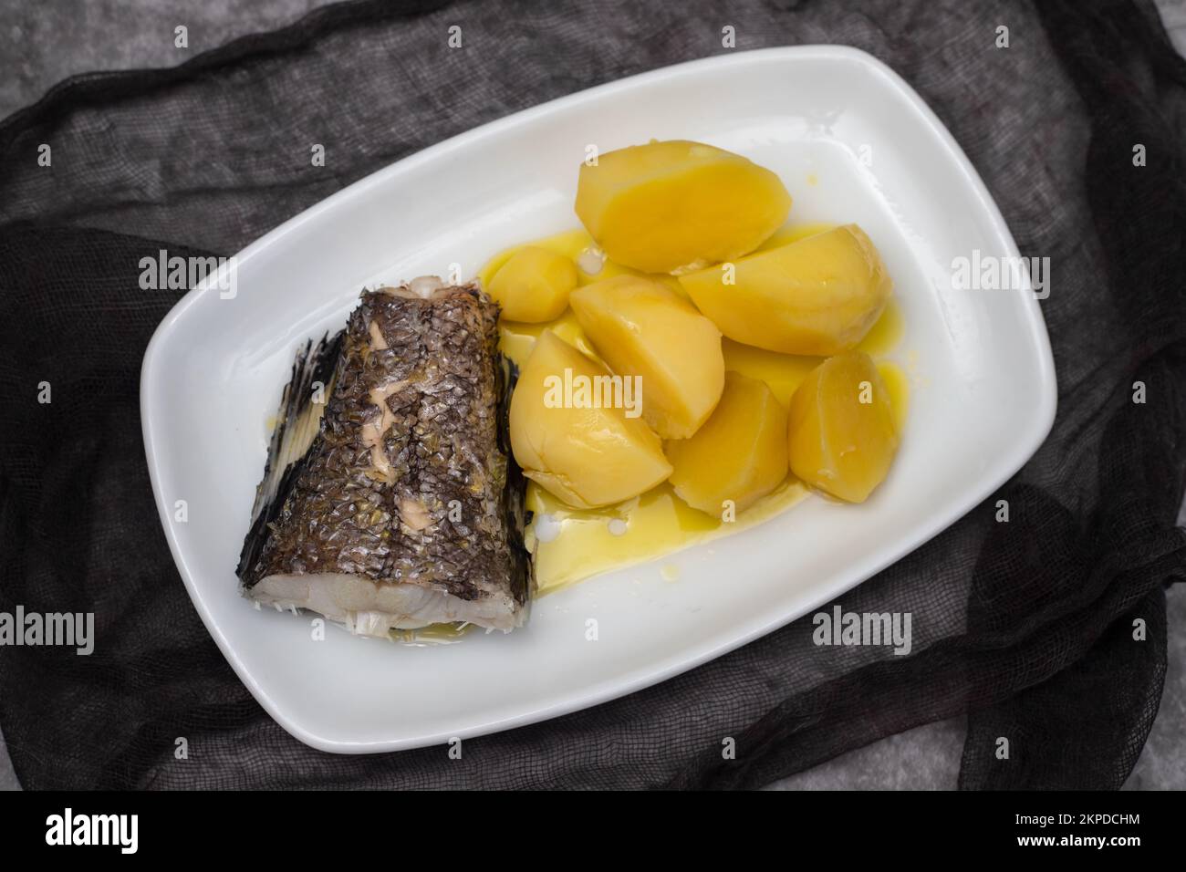 boiled fish with boiled potato on white plate Stock Photo - Alamy