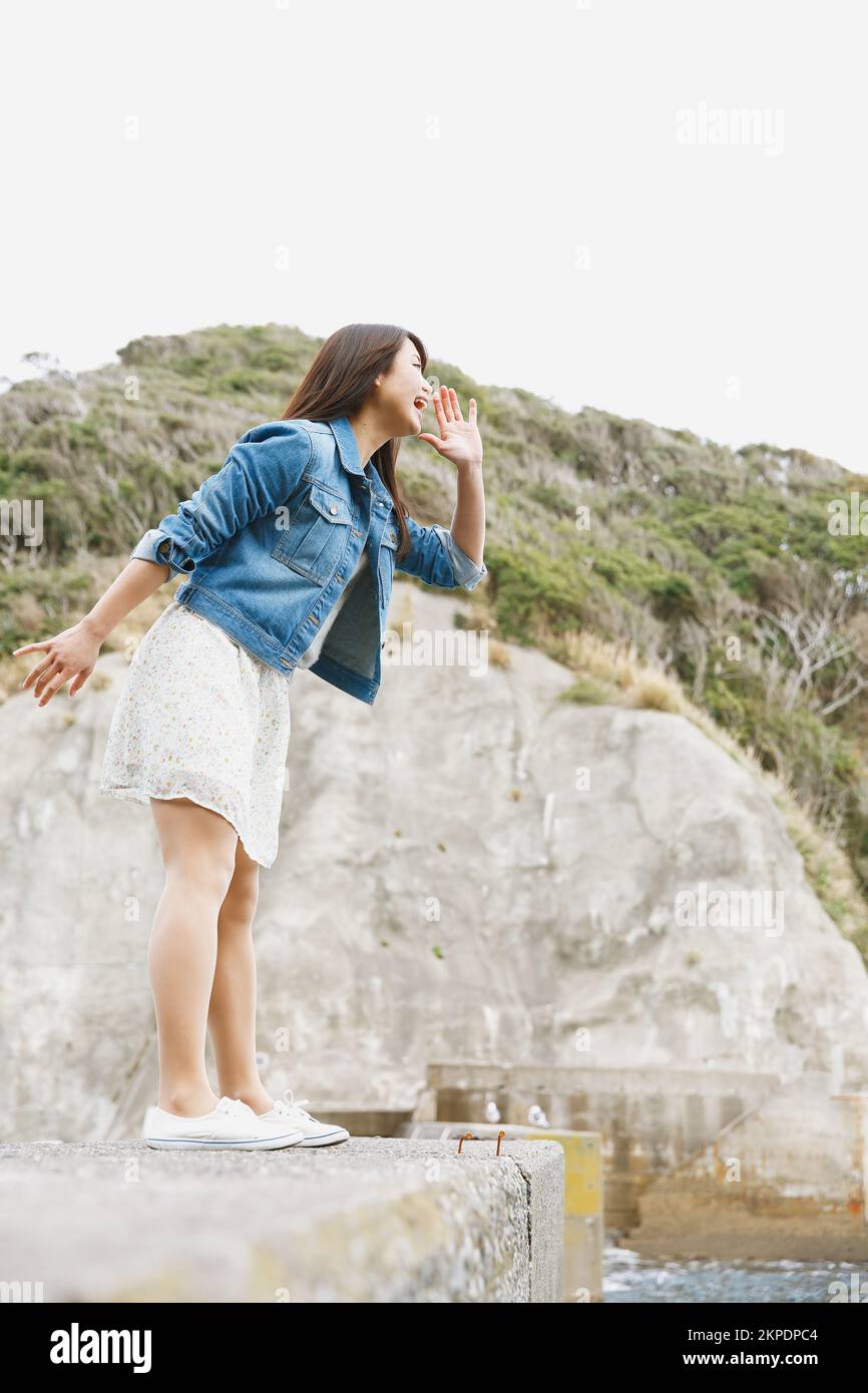 Japanese woman shouting towards the sea Stock Photo - Alamy