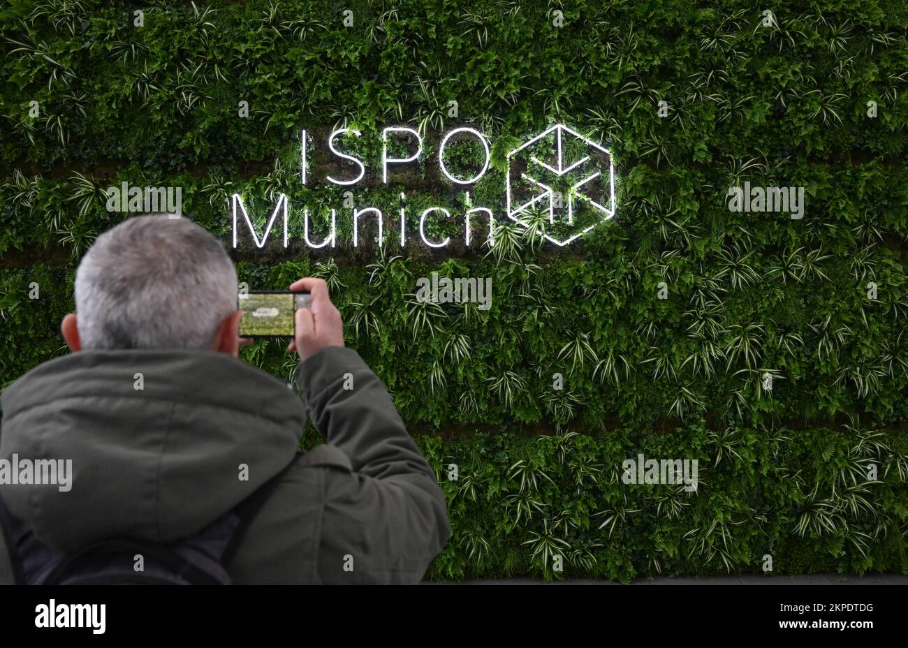 Munich, Germany. 28th Nov, 2022. A visitor takes a photo of the logo of ...