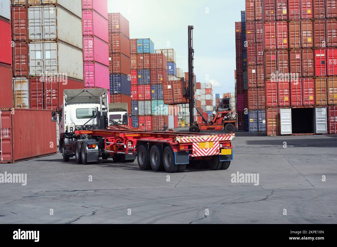 Container forklifts and trucks in the container yard Stock Photo - Alamy