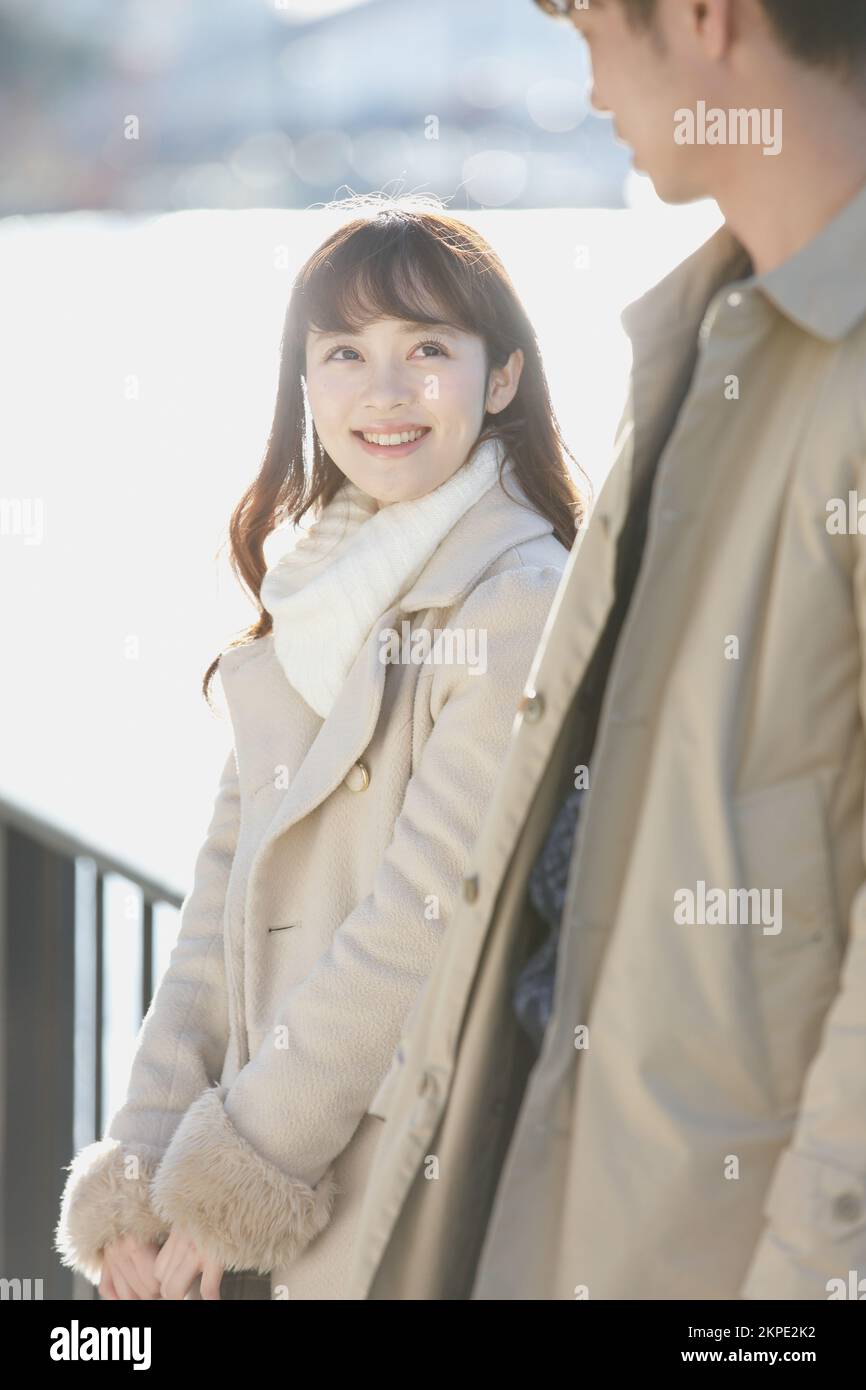 Japanese couple talking with a smile Stock Photo - Alamy
