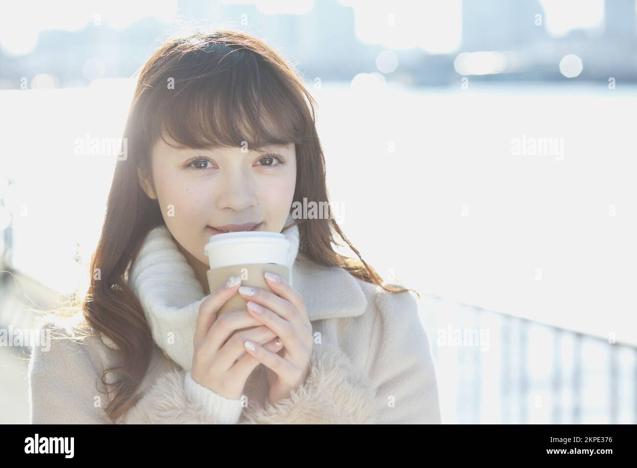 Japanese woman drinking coffee outside Stock Photo - Alamy