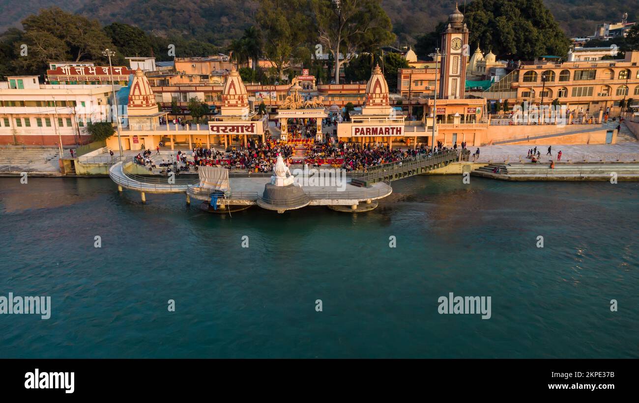 An aerial shot of a river with buildings on the shore at Rishikesh ...