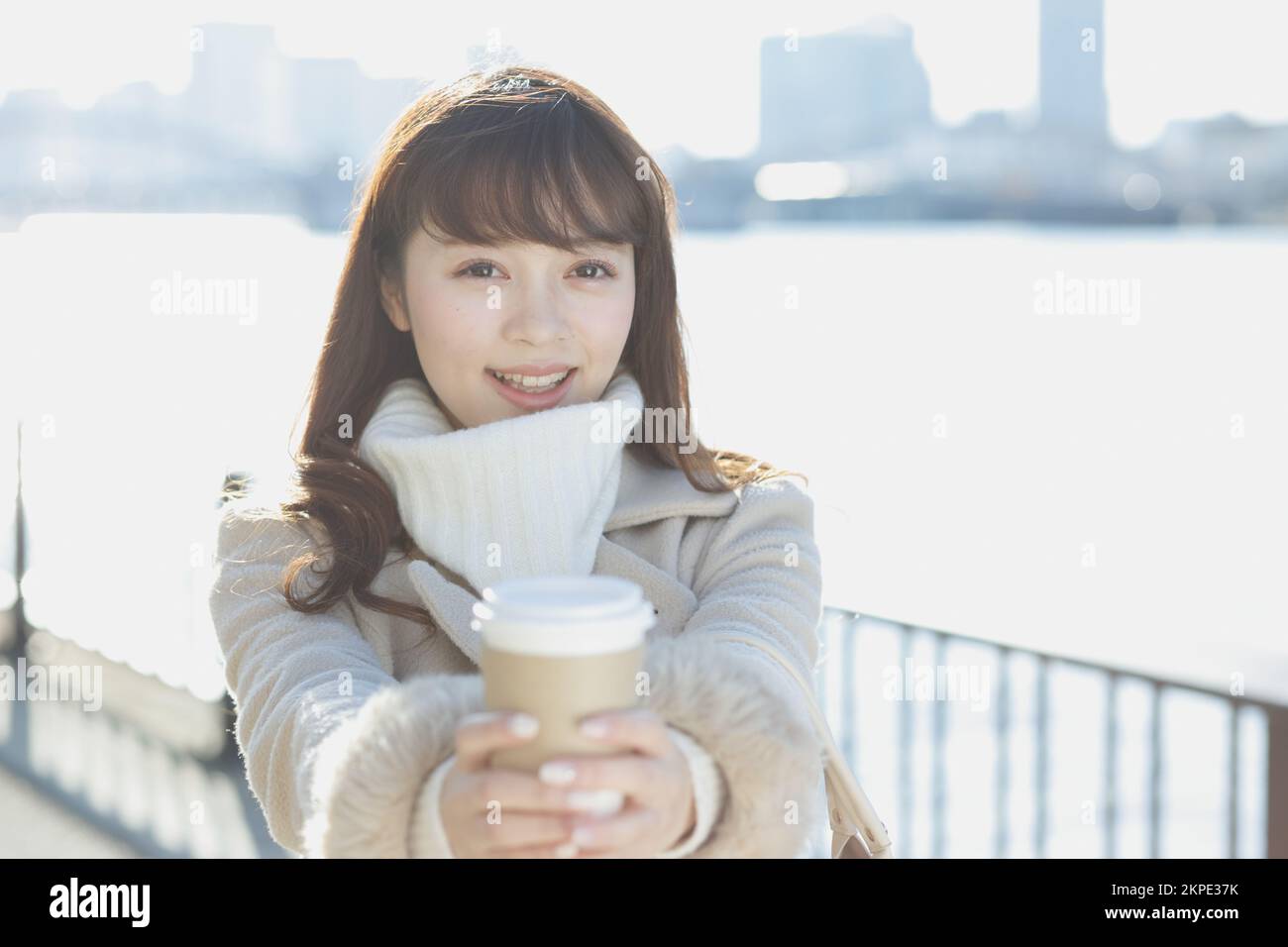 Japanese woman handing hot coffee Stock Photo - Alamy