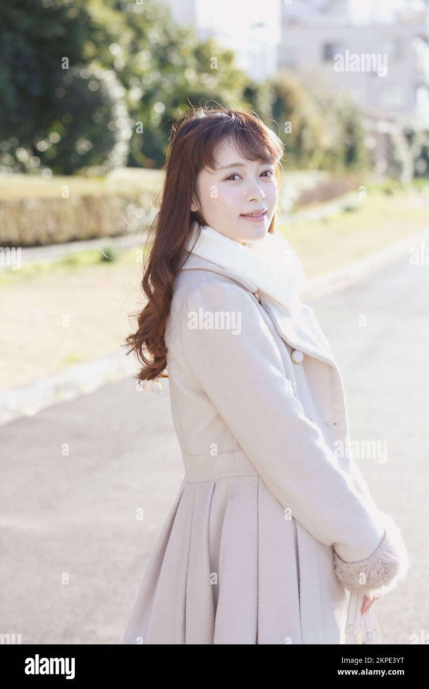 Japanese woman looking back with a smile Stock Photo - Alamy