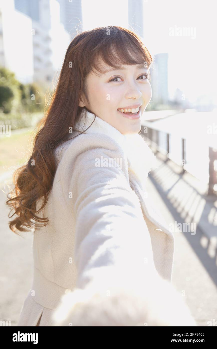 Japanese woman looking back with a smile Stock Photo - Alamy