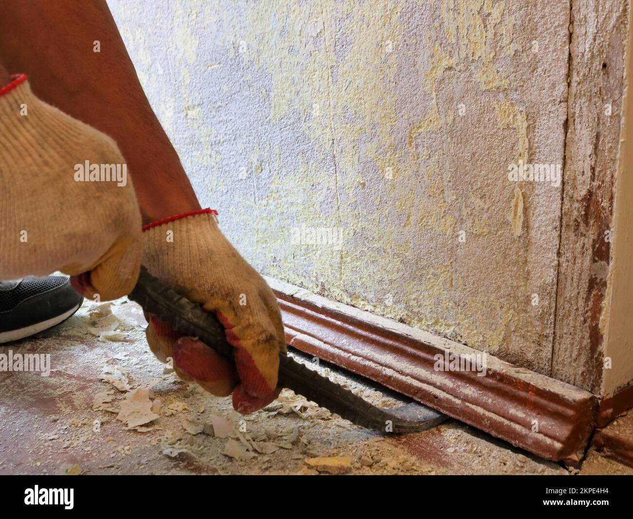 builder breaks out a wooden plinth in an old house in the process of a ...