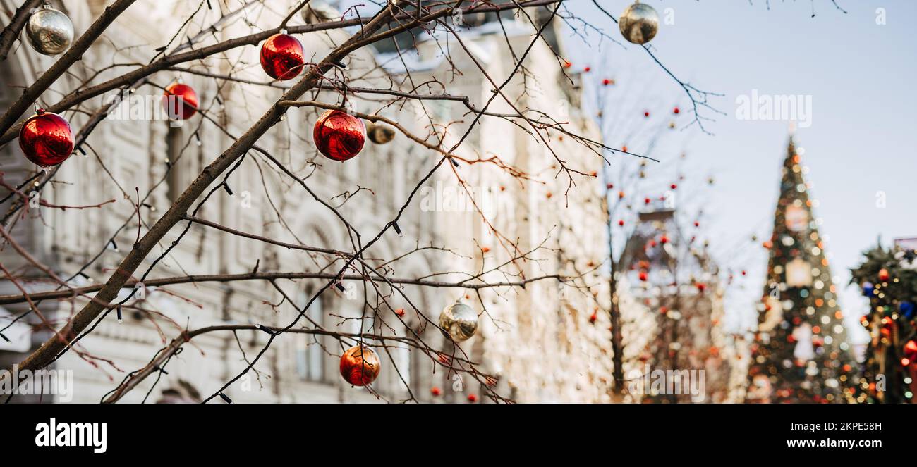 Close up of balls on christmas fir tree. Bokeh light garlands in ...