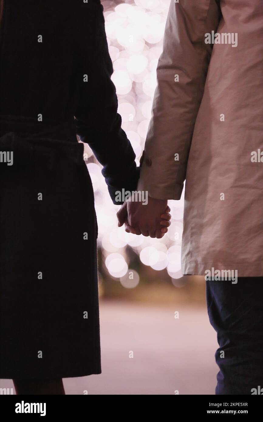 Back view of a couple holding hands Stock Photo - Alamy