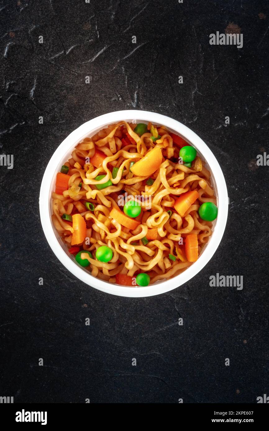 Ramen cup, instant soba noodles in a plastic cup with vegetables, shot ...