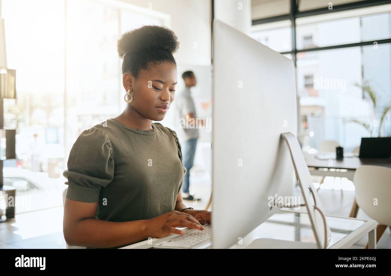 Black woman typing at computer hi-res stock photography and images - Alamy