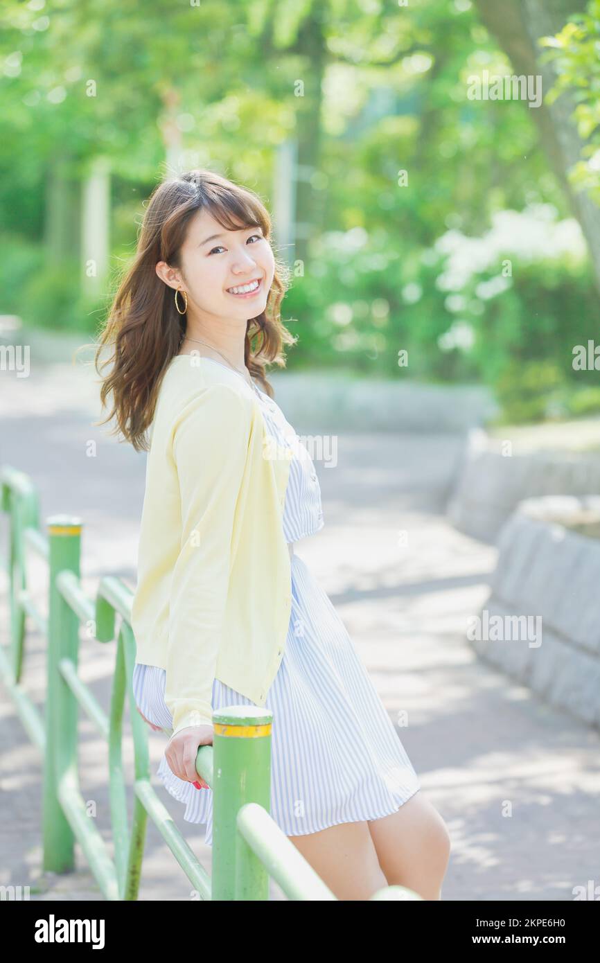 Japanese woman looking back with a smile Stock Photo - Alamy