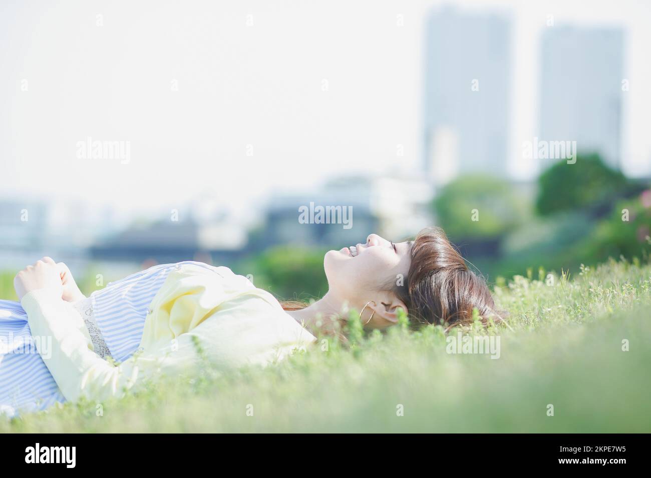 Japanese woman relaxing on the grass Stock Photo - Alamy