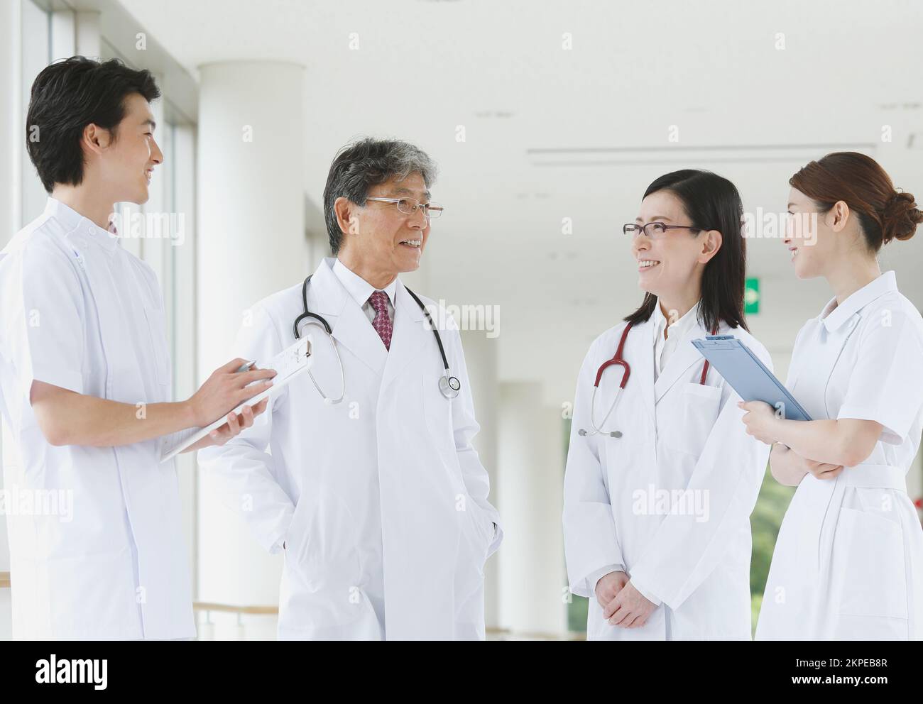 Smiling medical team having a conversation in the hallway Stock Photo ...