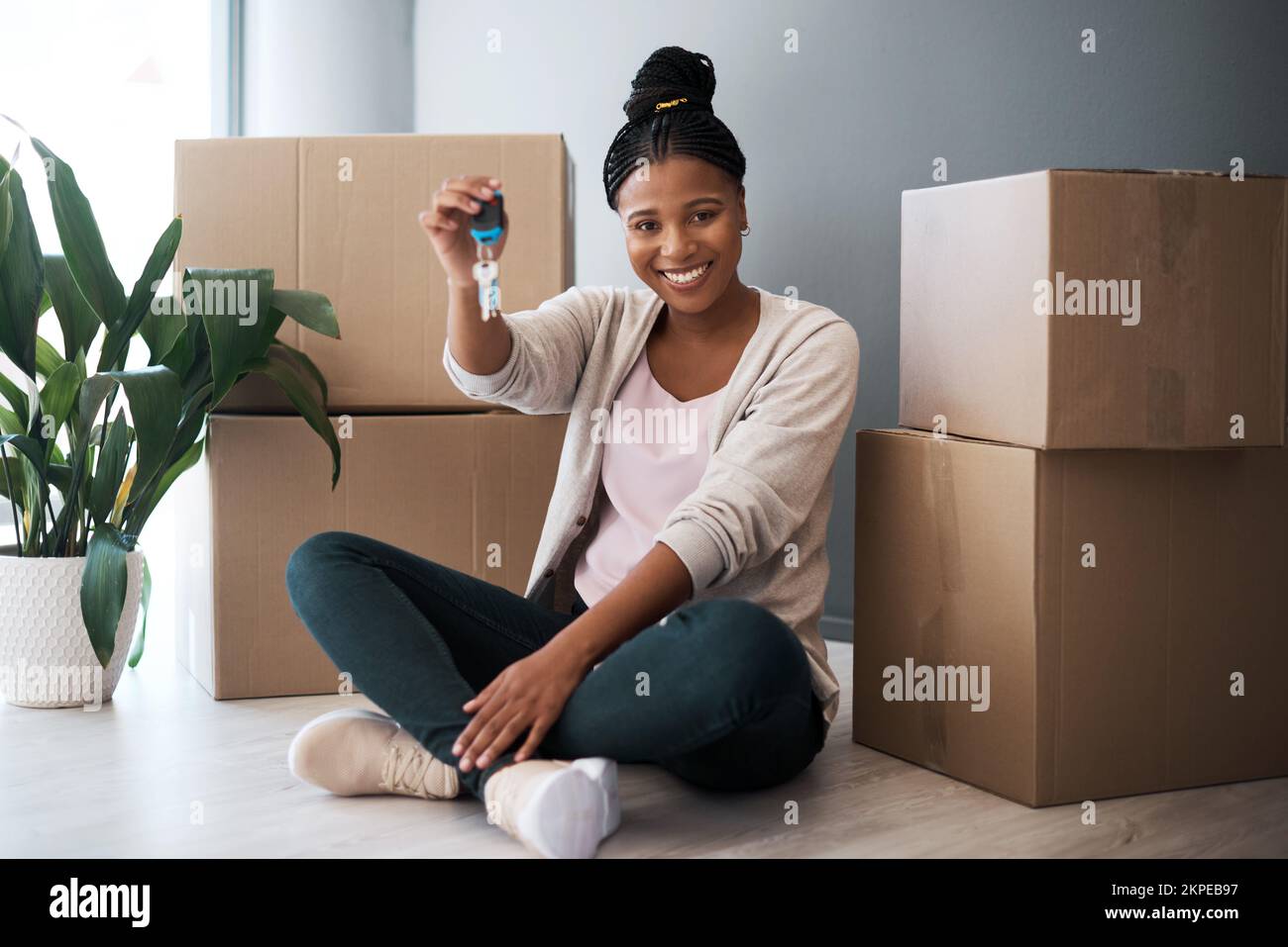 Boxes, black woman and homeowner with keys, to new home and happiness ...
