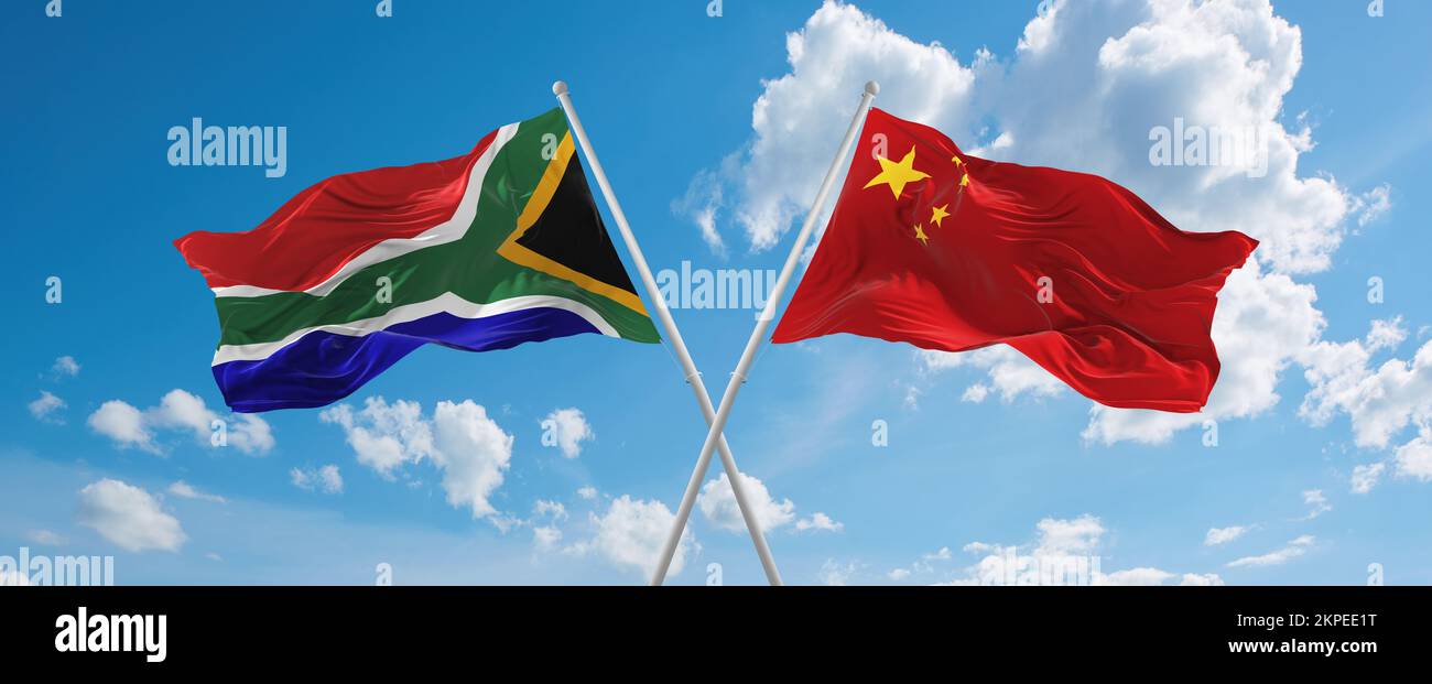 two crossed flags china and South Africa waving in wind at cloudy sky ...