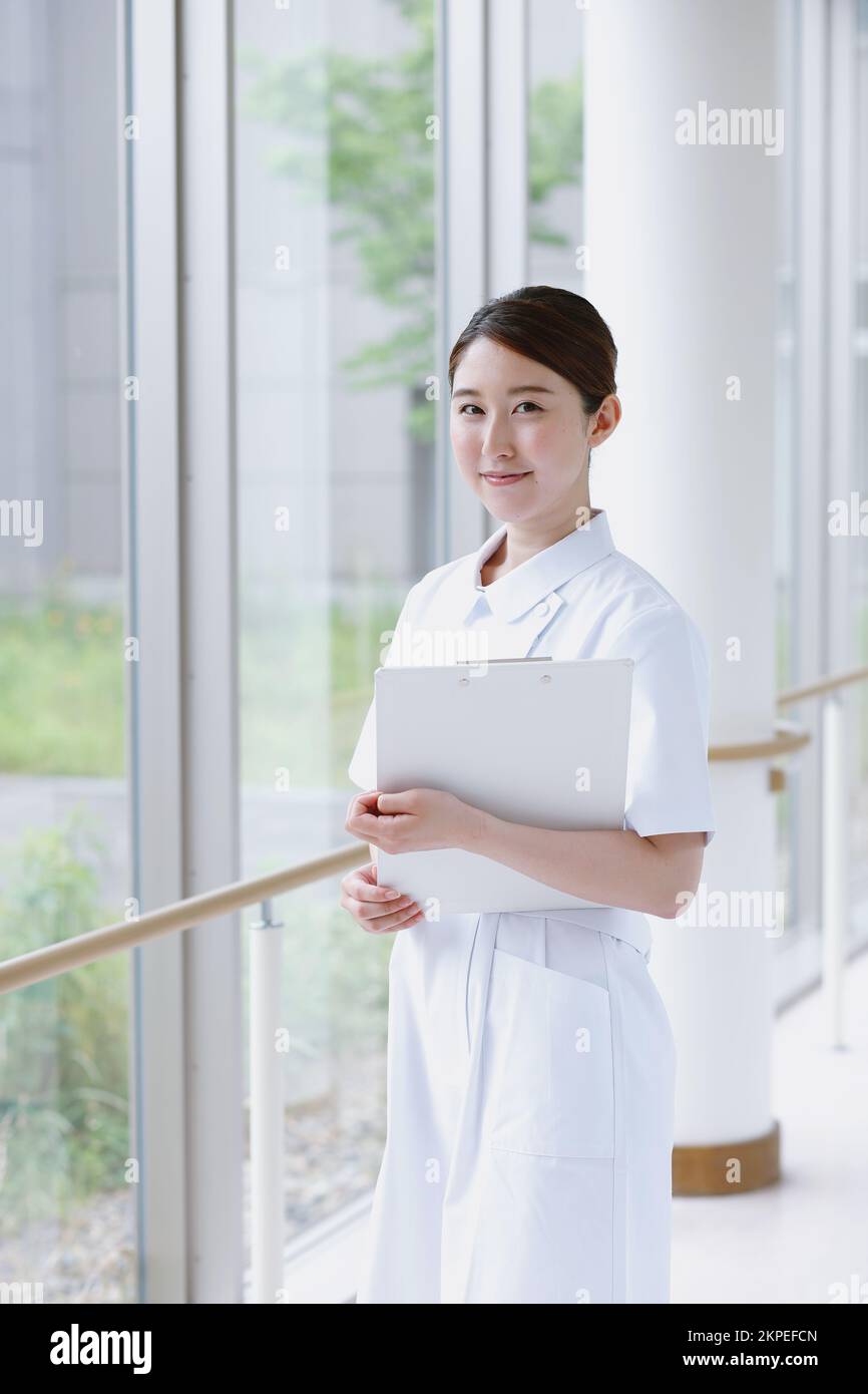 Young Japanese female nurse in the hallway Stock Photo - Alamy