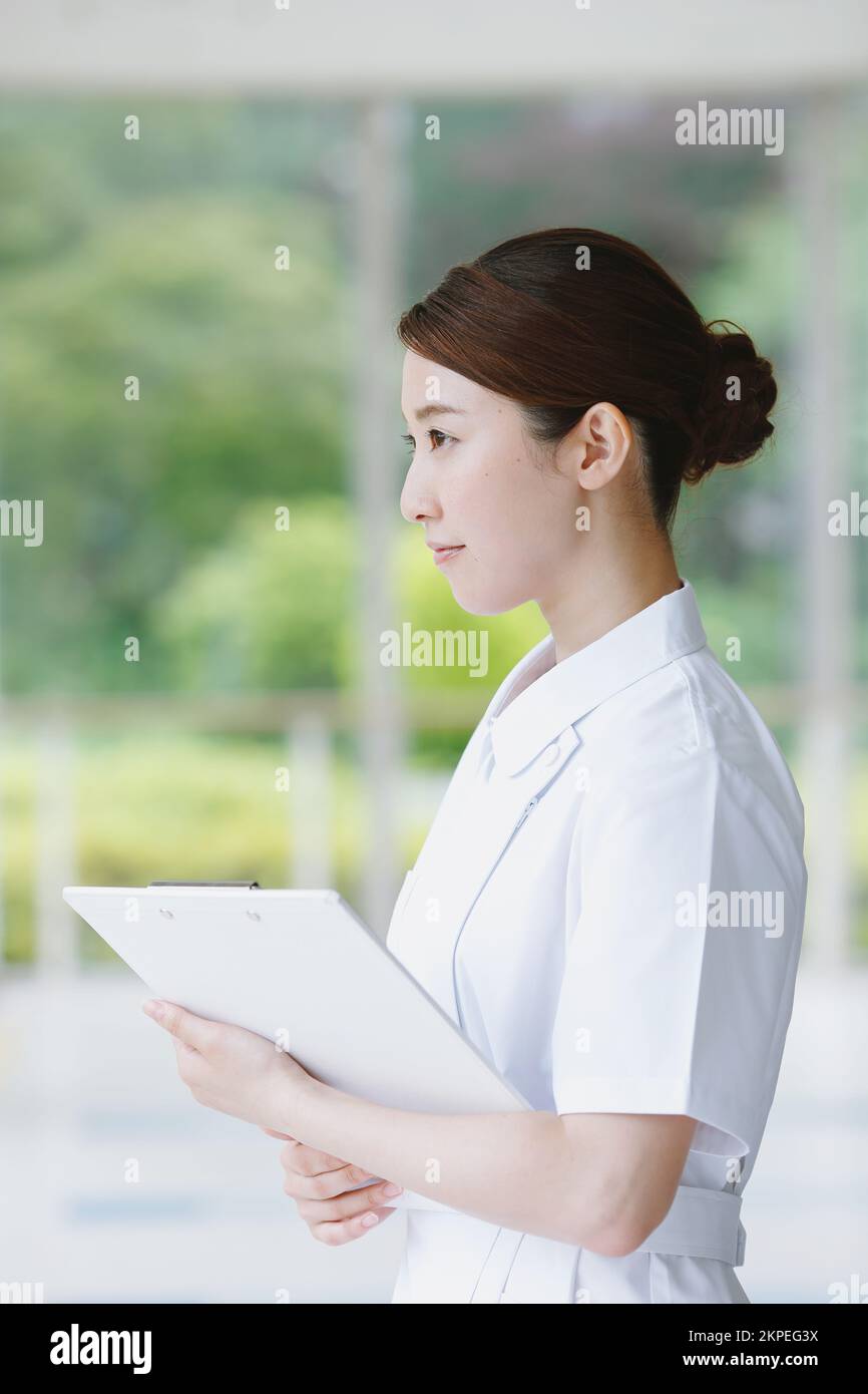 Young Japanese female nurse in the corridor Stock Photo - Alamy