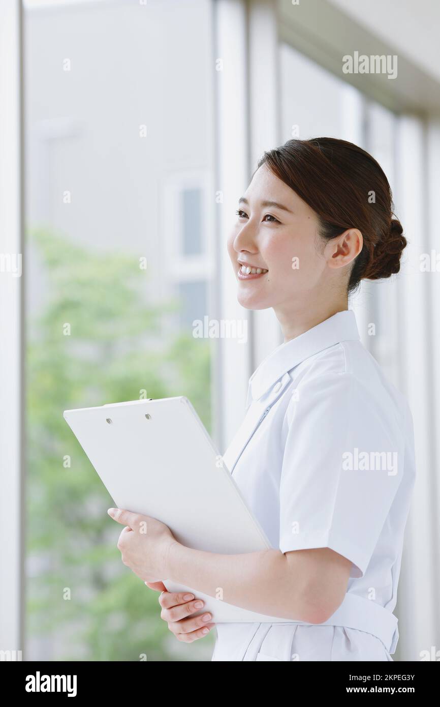 Smiling young Japanese female nurse in the hallway Stock Photo - Alamy