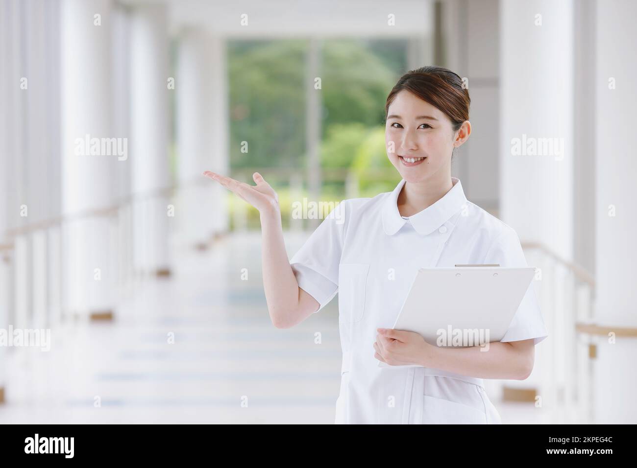 Smiling young Japanese female nurse in the hallway Stock Photo - Alamy