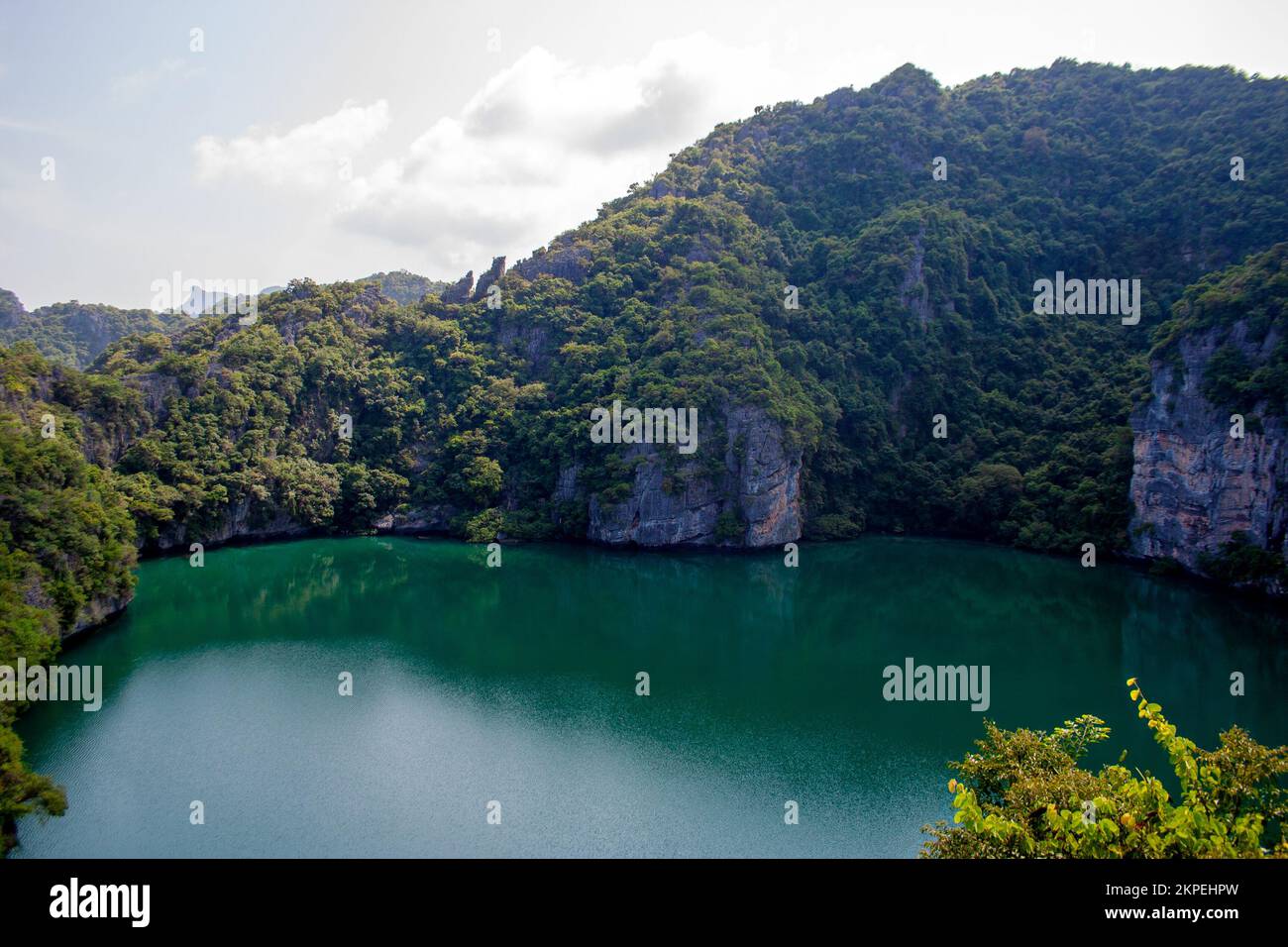 Beautiful lake of Ko Mae Ko island with tropical plants on rocky cliffs ...