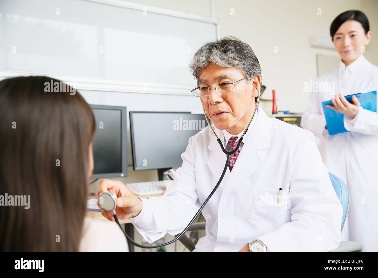 Japanese doctor examining Stock Photo - Alamy