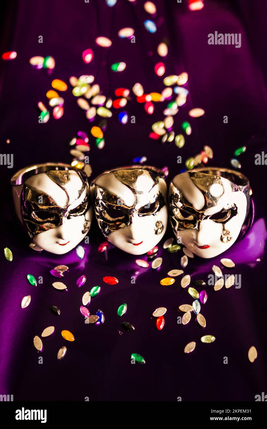 White carnival masks rings close-up, masquerade mask jewelry on purple ...