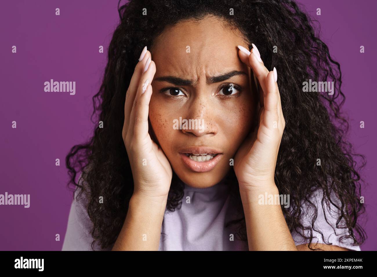 Young Black Woman With Wavy Hair Expressing Surprise At Camera Isolated