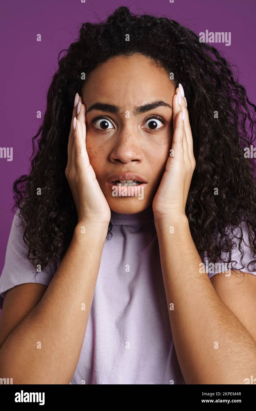 Young Black Woman With Wavy Hair Expressing Surprise At Camera Isolated