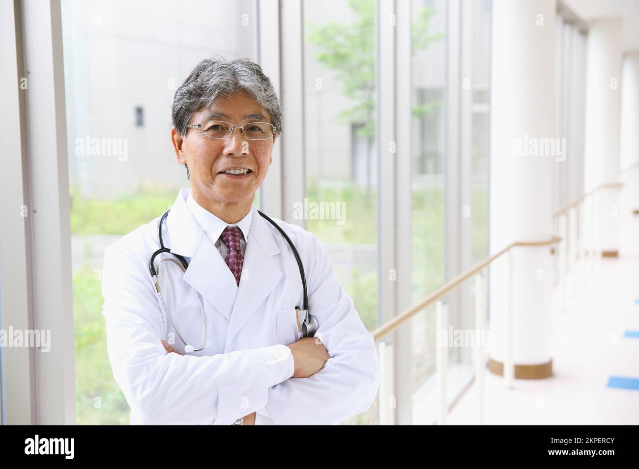 Smiling Japanese doctor in the hallway Stock Photo - Alamy