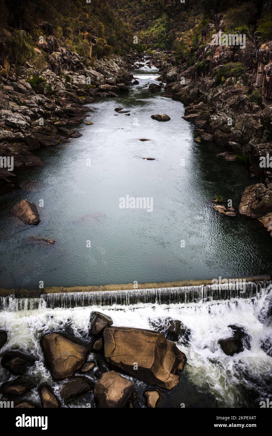 Pristine river landscape of a flowing water canyon with rock waterfall ...