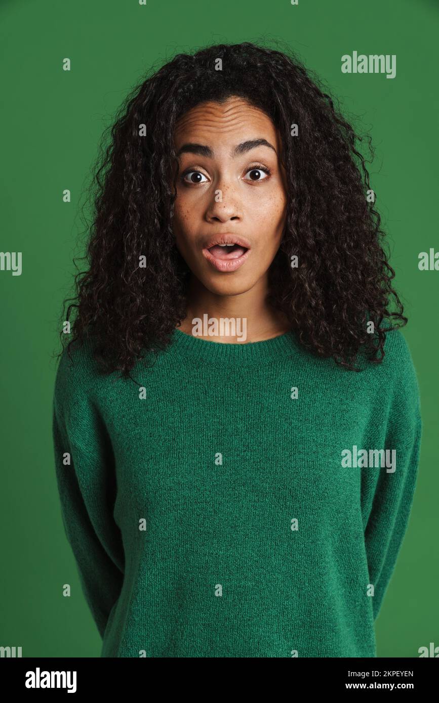 Young Black Woman With Wavy Hair Expressing Surprise At Camera Isolated