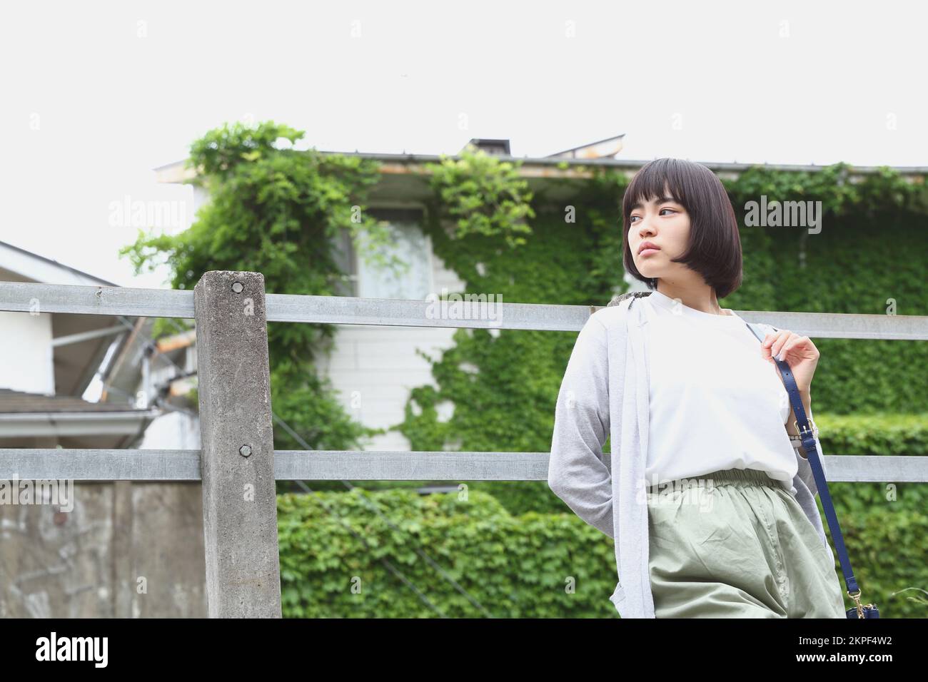 Young Japanese woman by the railway fence Stock Photo - Alamy