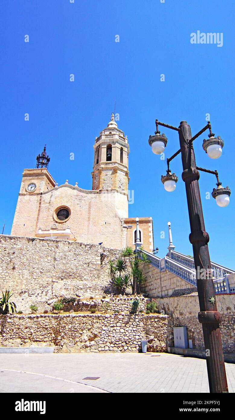 Grass roundabout and lampposts with the church of San Bartolome and ...