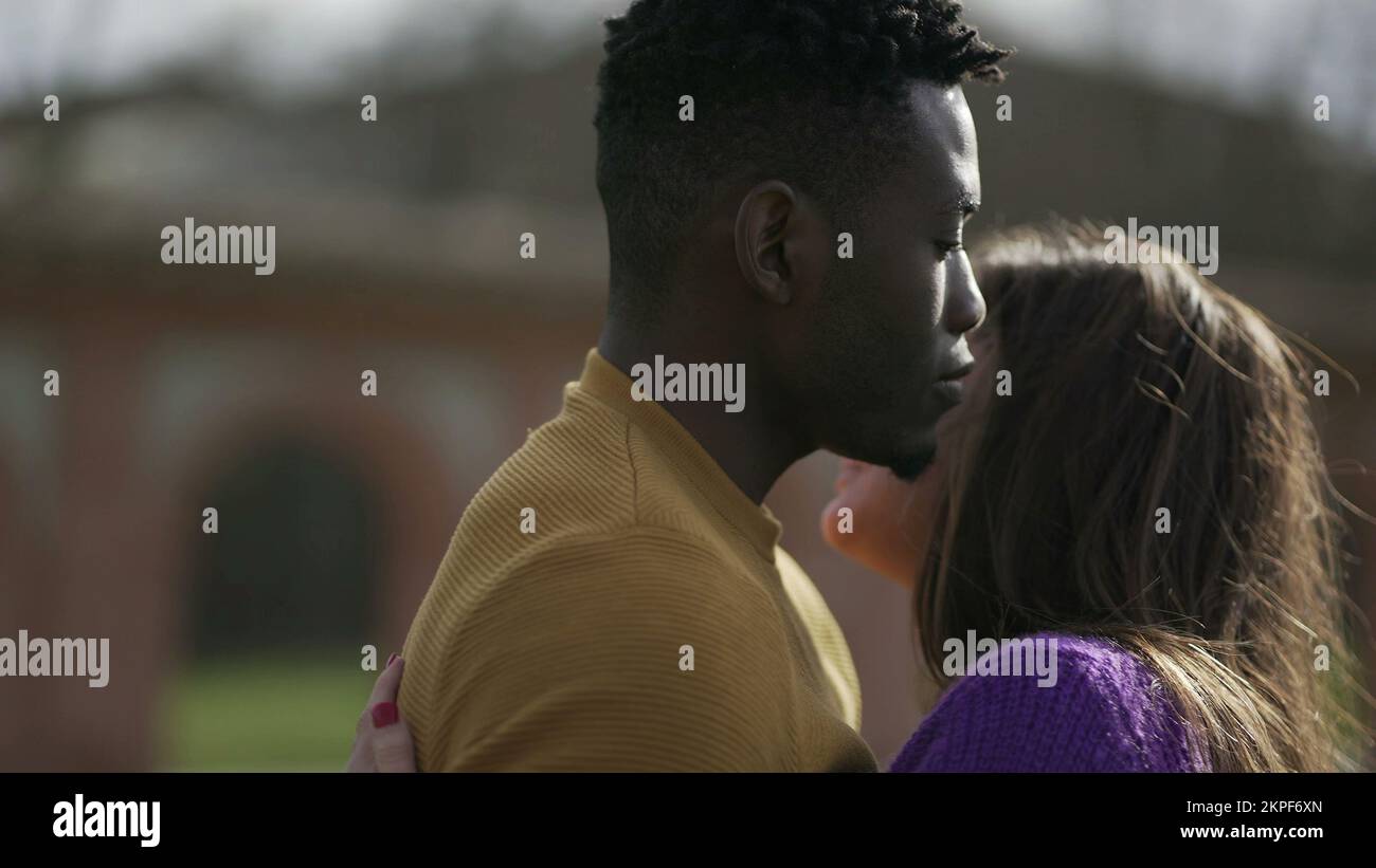 Interracial couple empathic embrace. Young woman romantic connection ...
