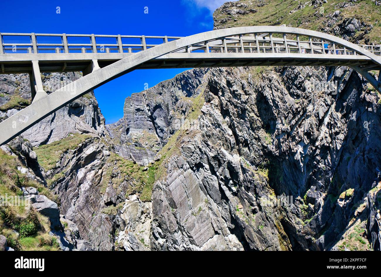 Reinforced concrete footbridge over dramatic sea gorge linking Cloghane ...