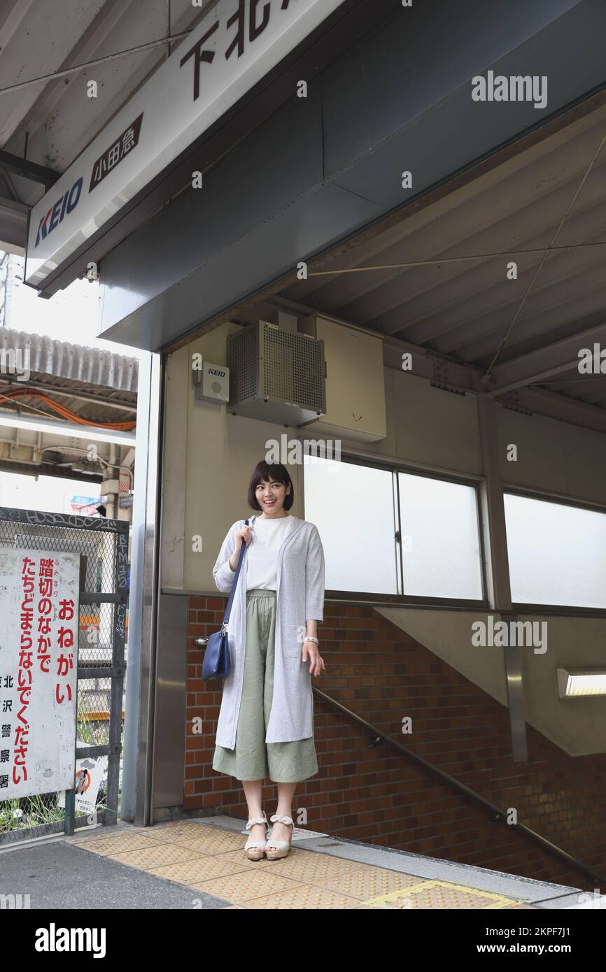 Young Japanese woman exiting the train station Stock Photo - Alamy