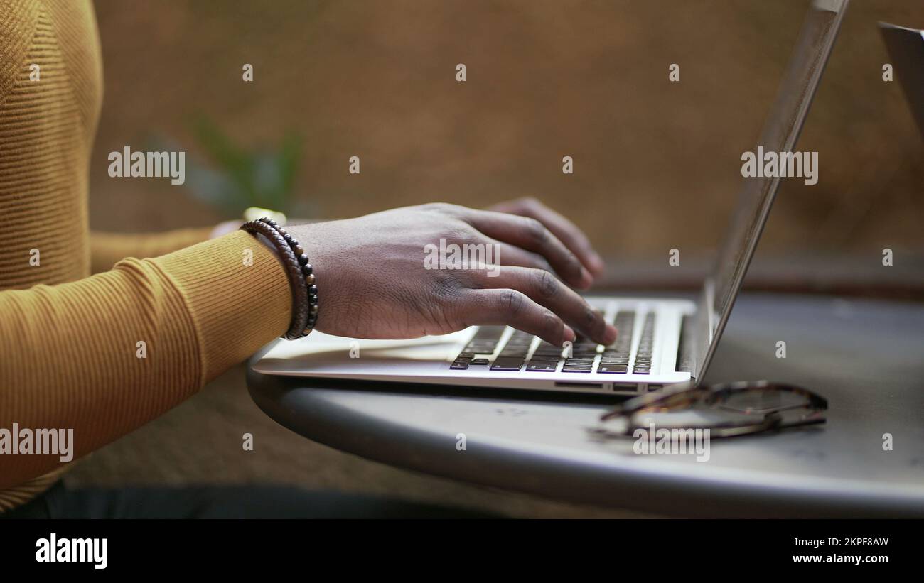 Close-up African man hands typing laptop computer keyboard Stock Photo ...