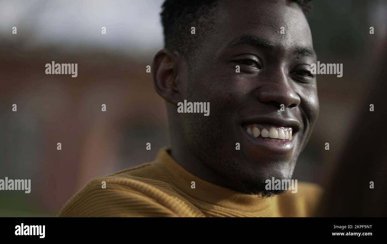 Happy black African man smiling and laughing portrait face close-up ...