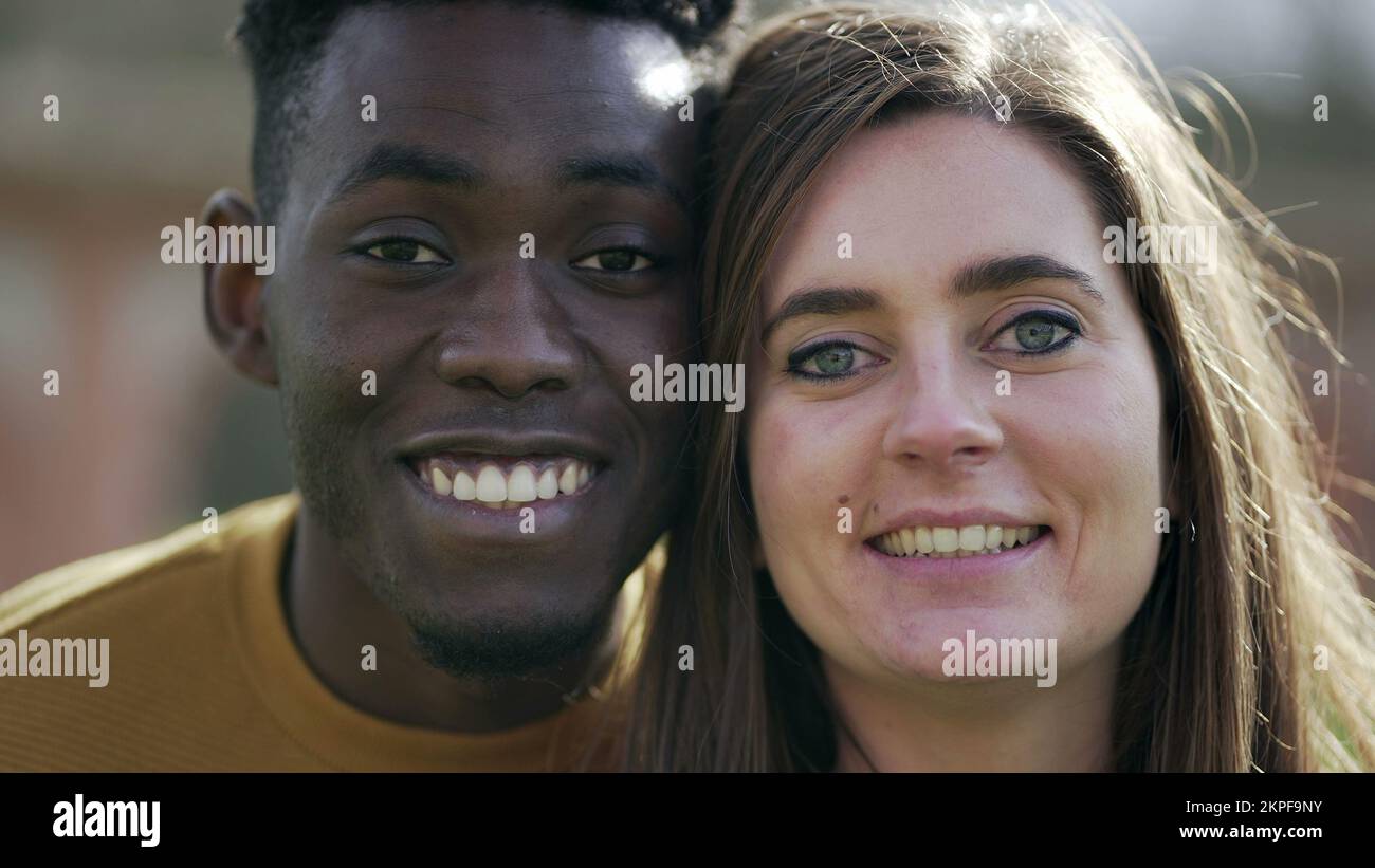 Happy diverse couple smiling at camera. African man and white girl face ...