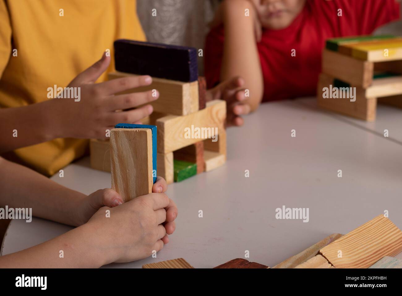 Children construct wooden colorful blocks at home Stock Photo - Alamy