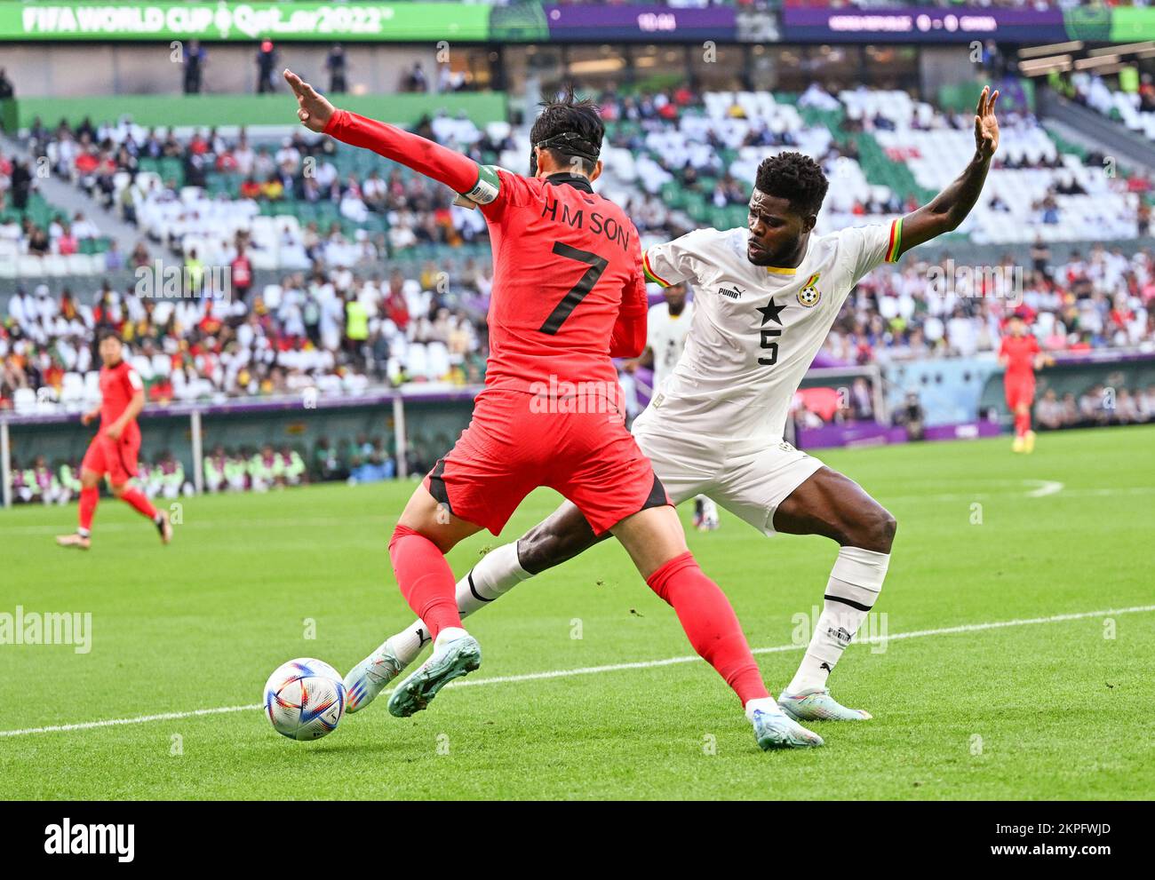 Al Rayyan, Qatar. 28th Nov, 2022. Son Heung-min (L) of South Korea vies with Thomas Partey of ...