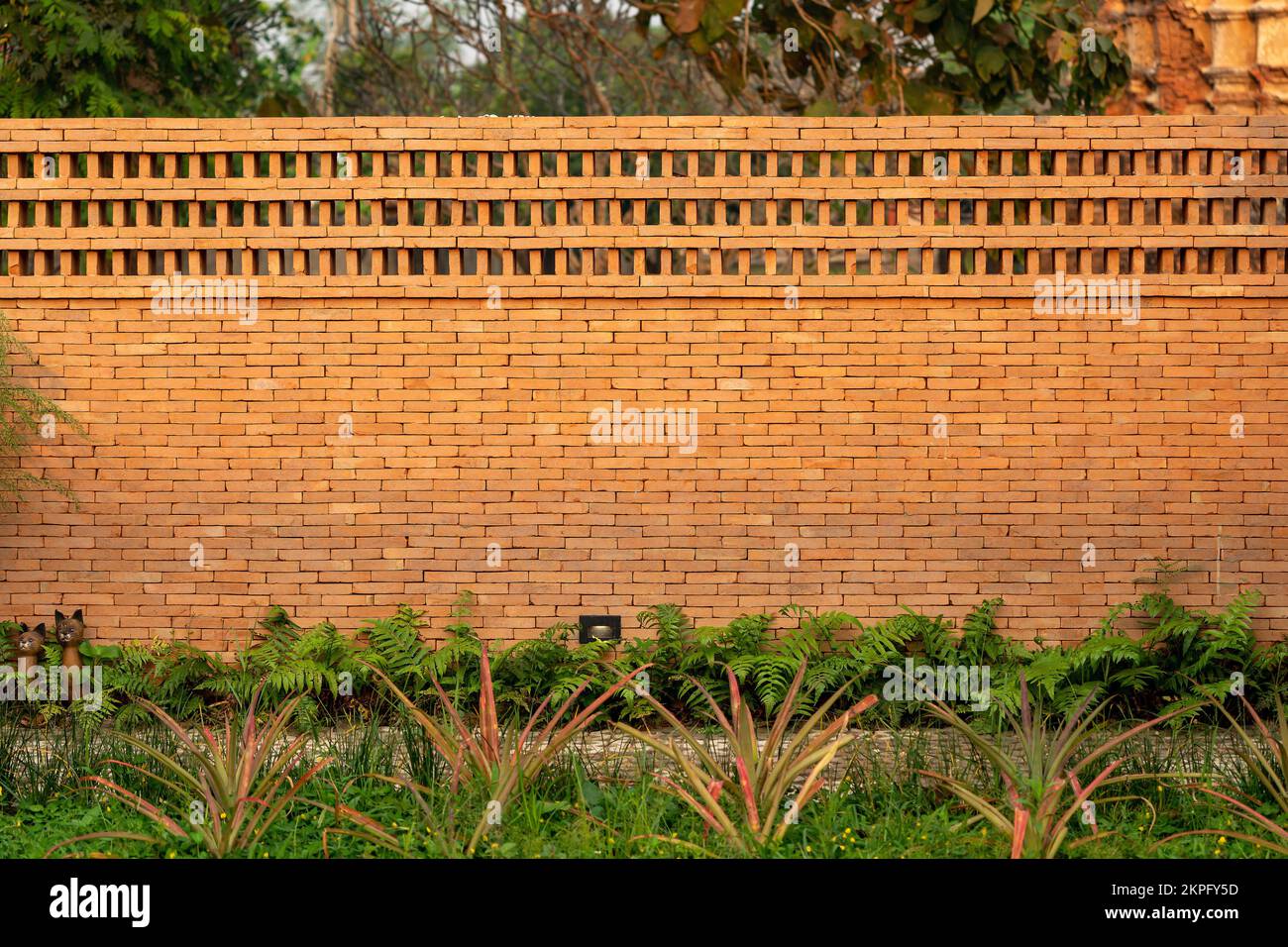 The brick wall, fence barrier is designed with a hole on top of wall in ...