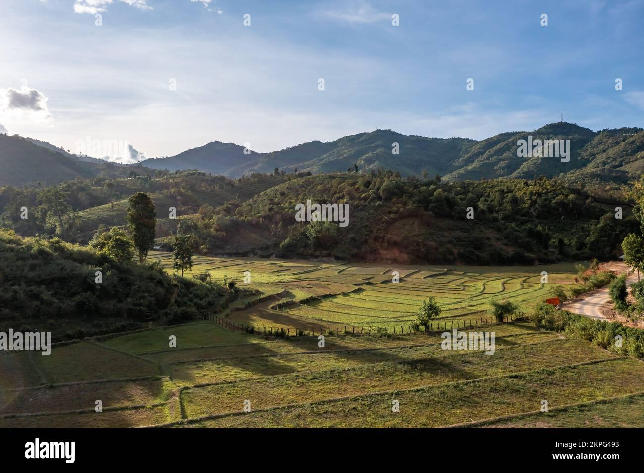 Aerial view of terraced agriculture field among greenery mountains with ...