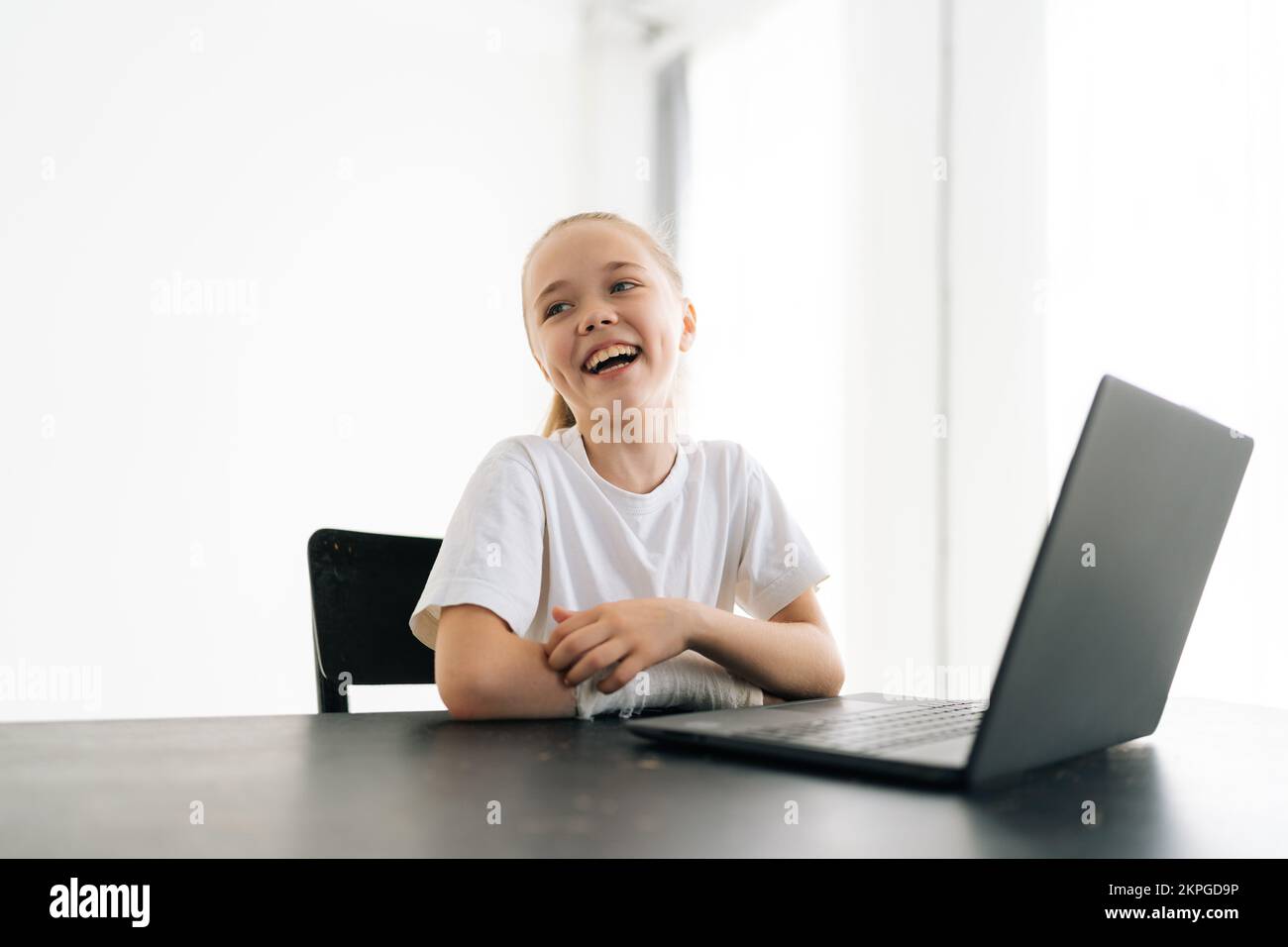 Laughing blonde little girl with broken hand wrapped in white plaster ...