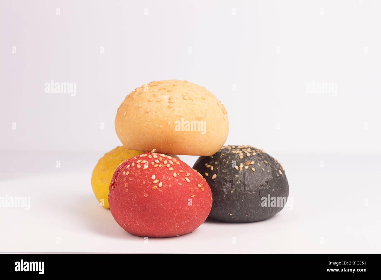 Colorful seasoned bread resting on a white background Stock Photo - Alamy