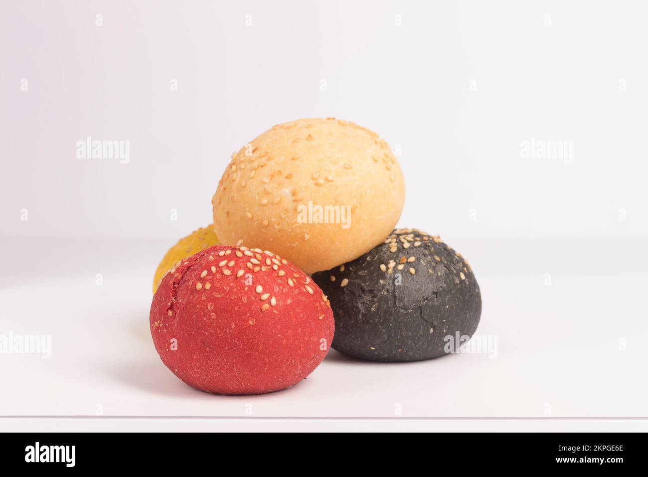 Colorful seasoned bread resting on a white background Stock Photo - Alamy